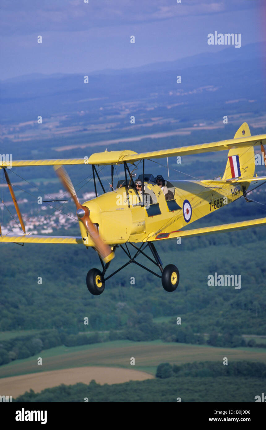 Old British trainer biplane De Havilland DH-82c Tiger Moth in flight ...