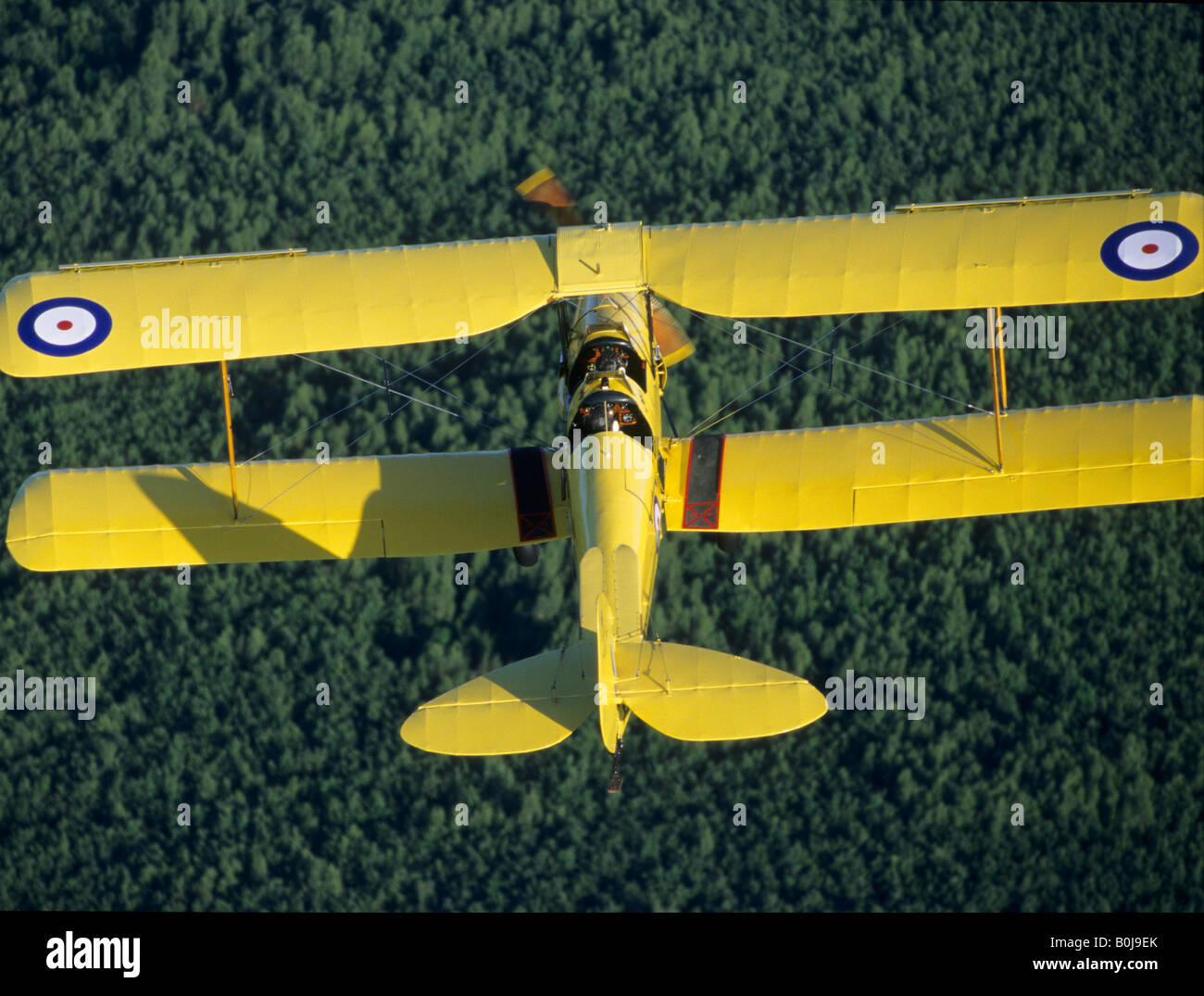 Old British trainer biplane De Havilland DH-82c Tiger Moth in flight ...