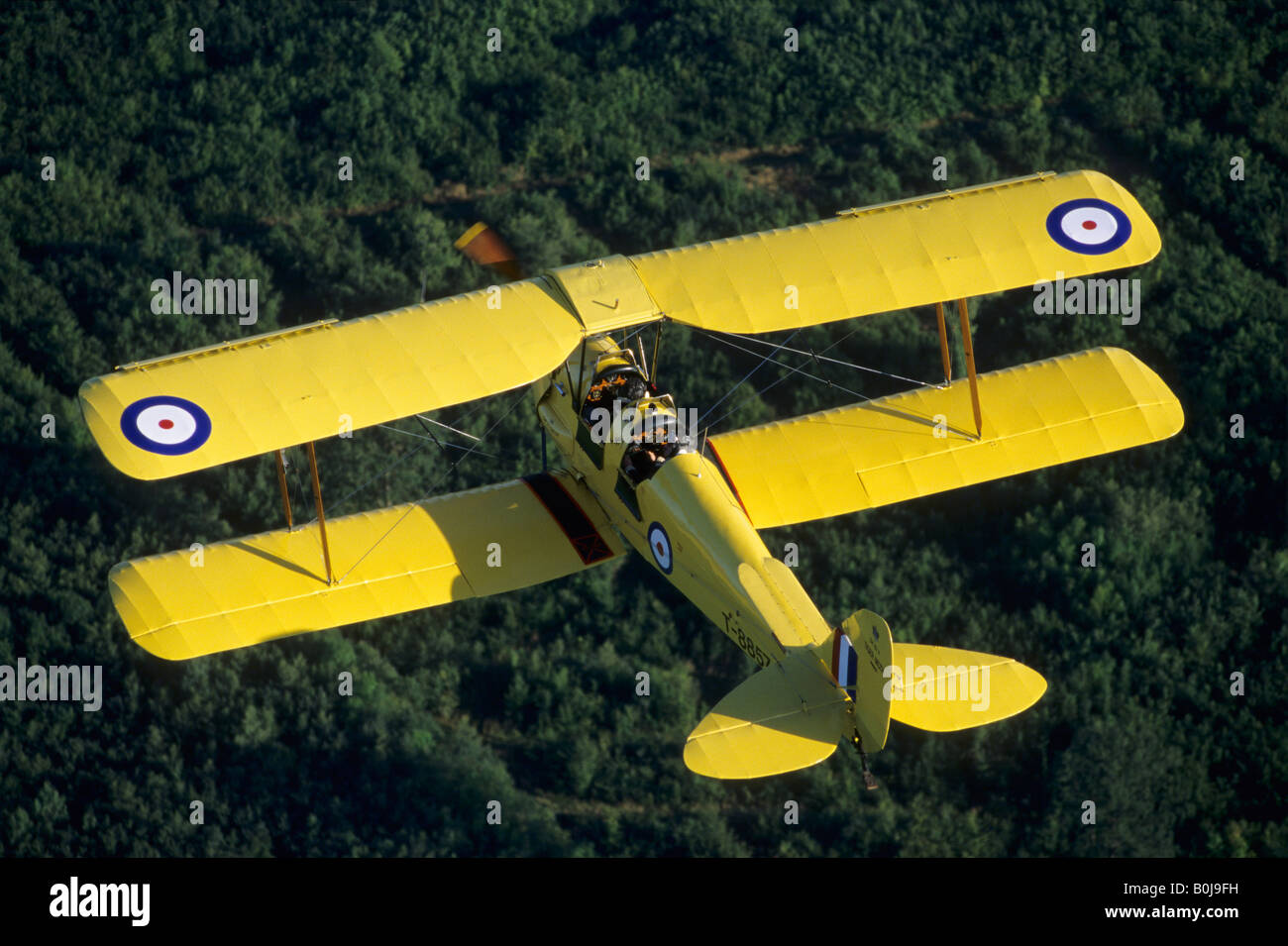 Old British trainer biplane De Havilland DH-82c Tiger Moth in flight ...