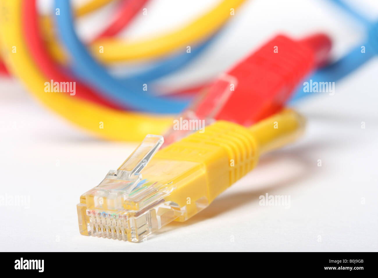 Category 5 network cables isolated on white three different colors red ...