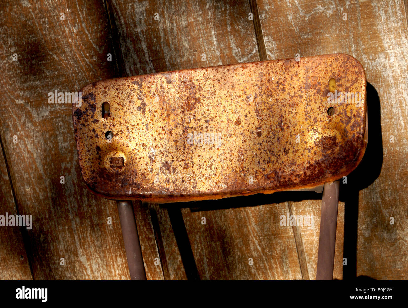 rusty metal antique chair with brown shadowed wood background Stock ...
