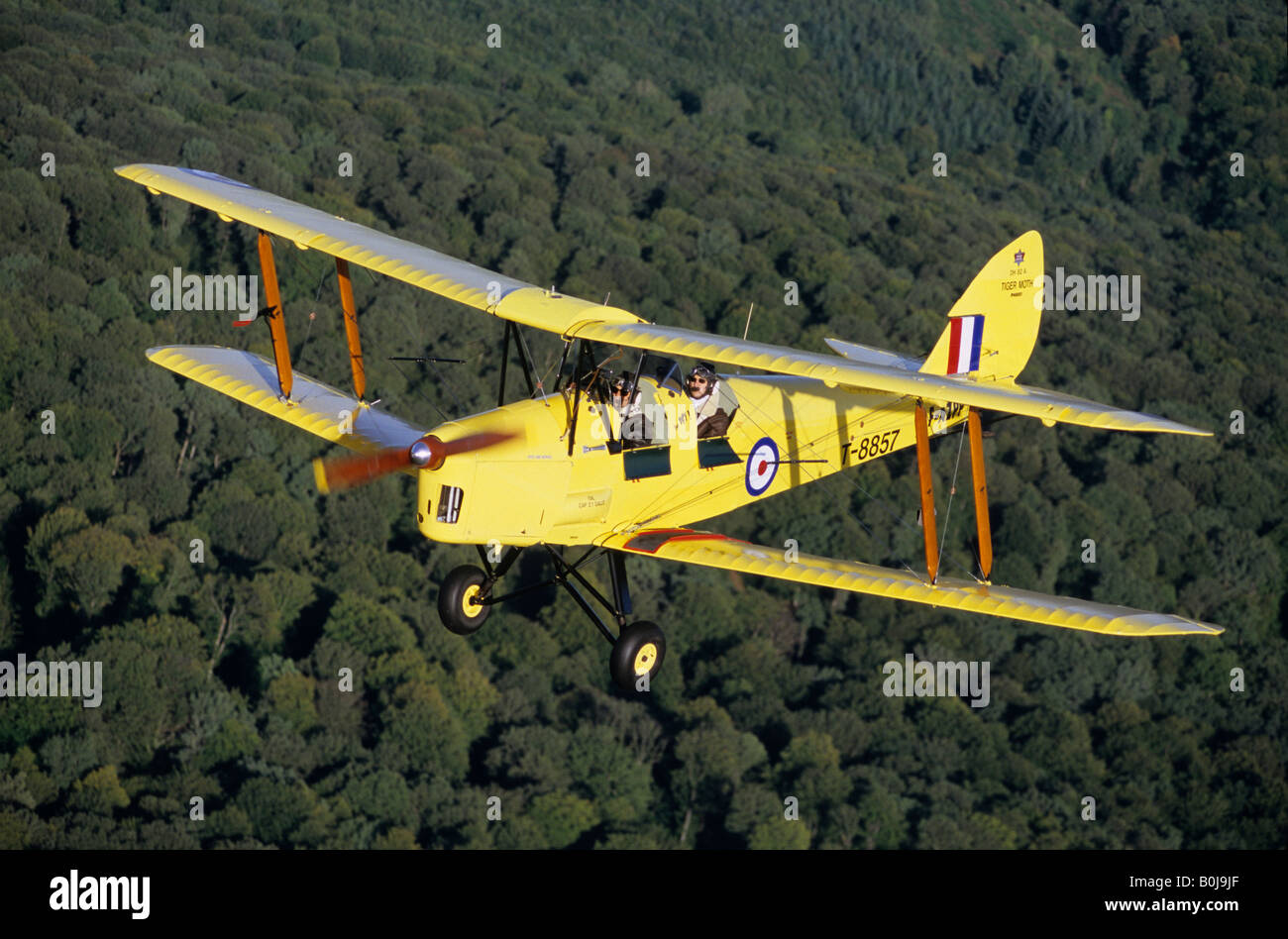 Old British trainer biplane De Havilland DH-82c Tiger Moth in flight ...