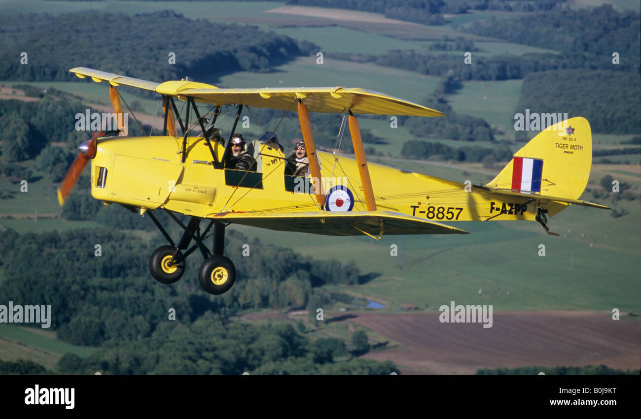 Old British trainer biplane De Havilland DH-82c Tiger Moth in flight ...