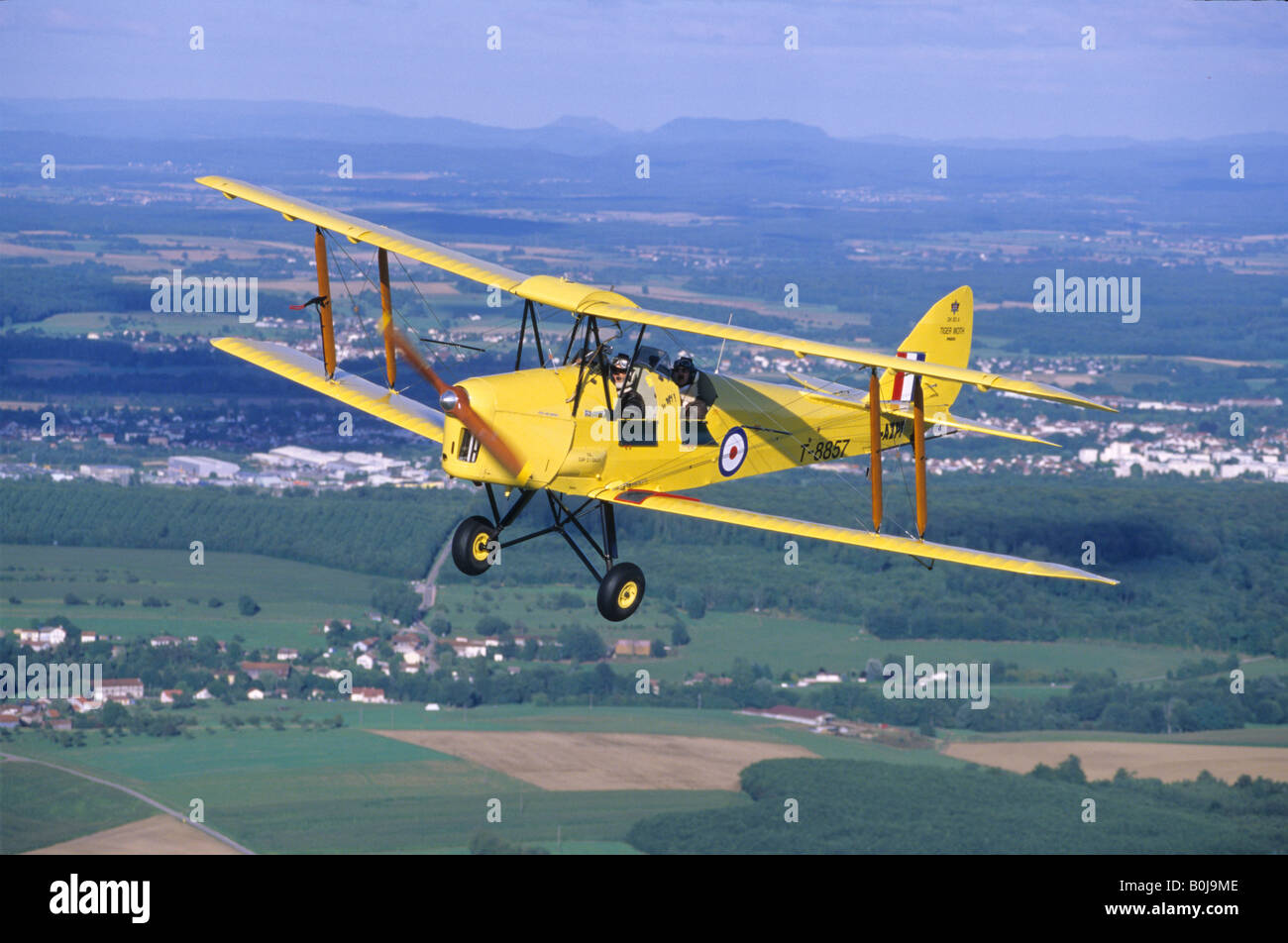 Old British trainer biplane De Havilland DH-82c Tiger Moth in flight ...