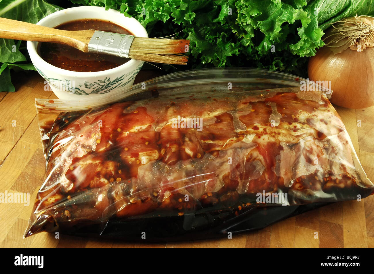 Fresh pork baby back ribs marinating in a plastic bag on a kitchen ...
