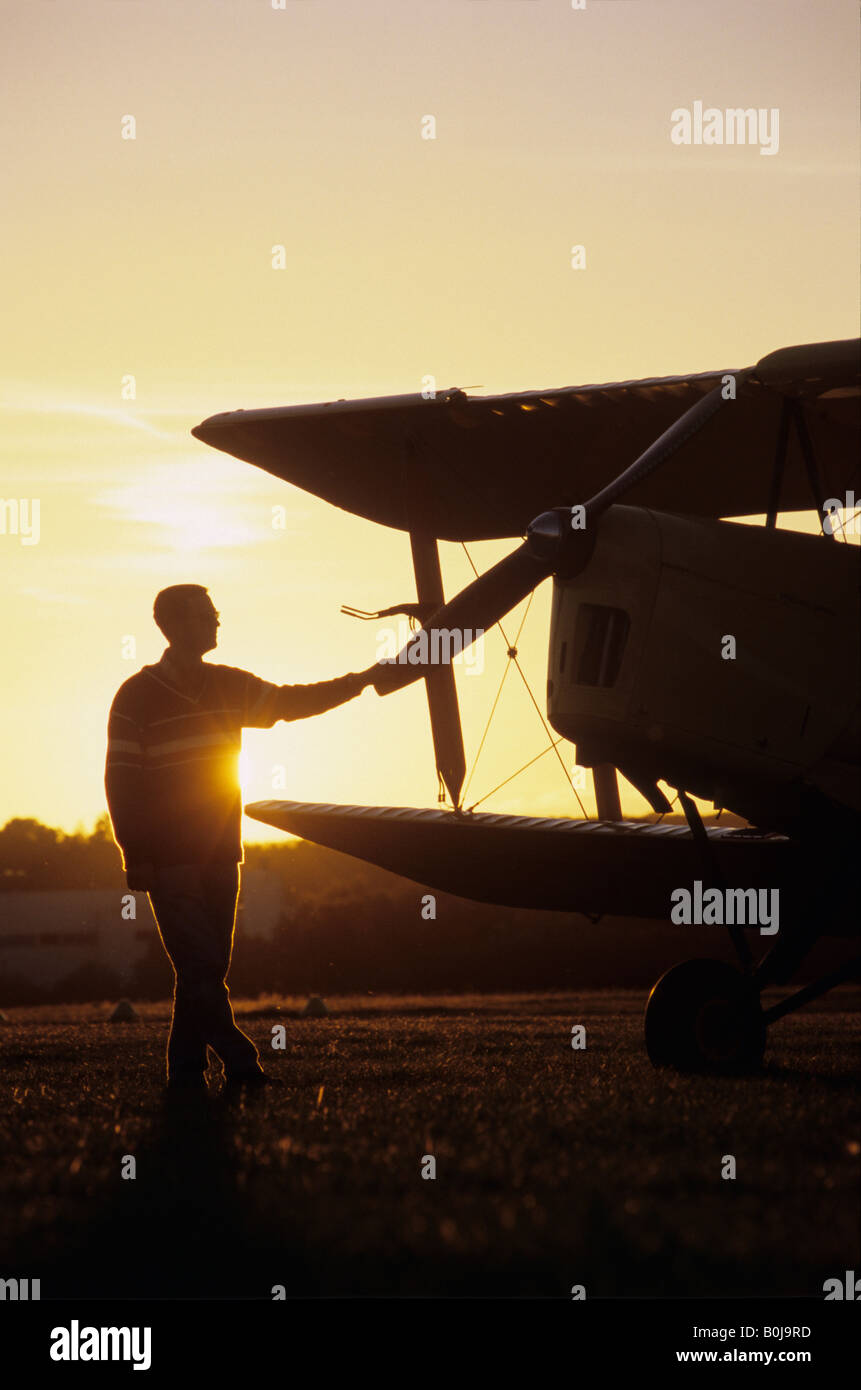 Pilot near an old trainer biplane De Havilland DH 82c Tiger Moth on ...
