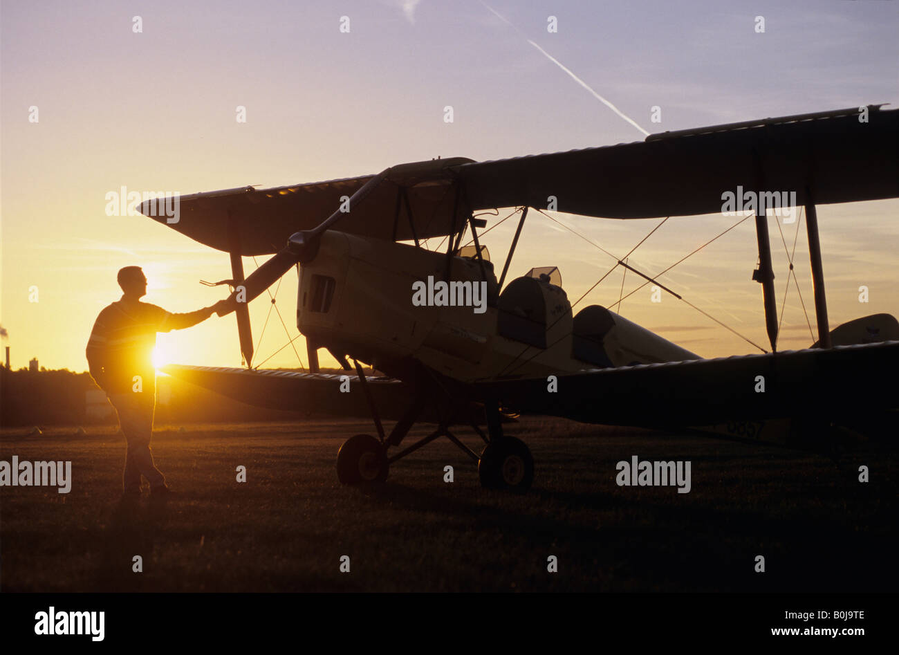 Pilot near an old trainer biplane De Havilland DH 82c Tiger Moth on ...