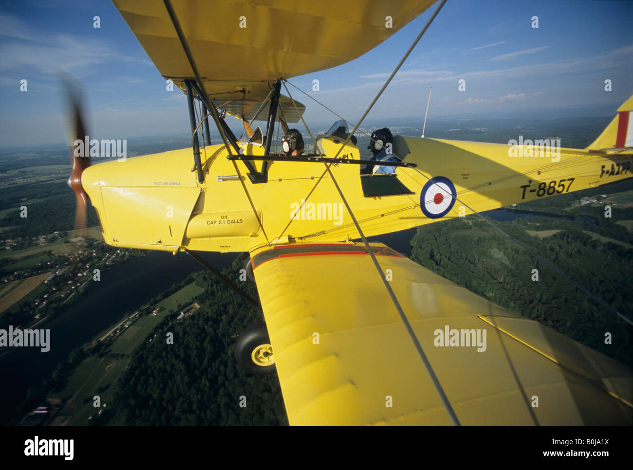 Old British trainer biplane De Havilland DH-82c Tiger Moth in flight ...
