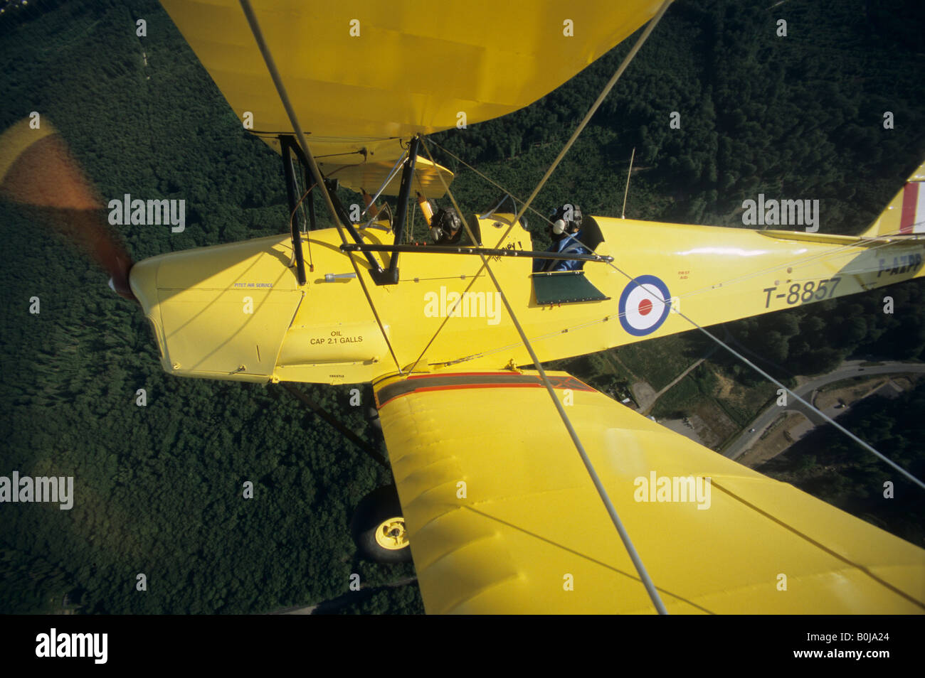 Old British trainer biplane De Havilland DH-82c Tiger Moth in flight ...