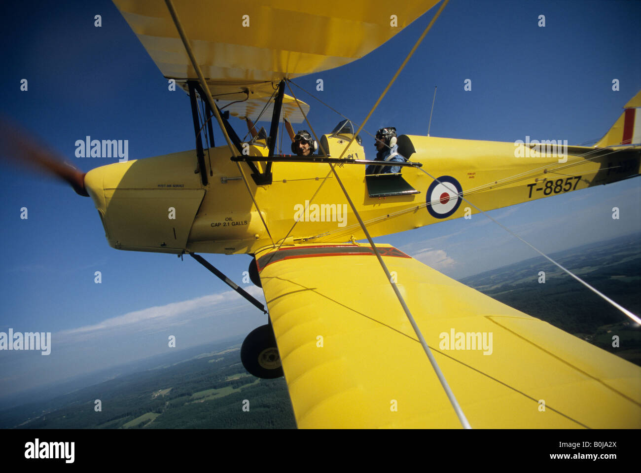 Old British trainer biplane De Havilland DH-82c Tiger Moth in flight ...