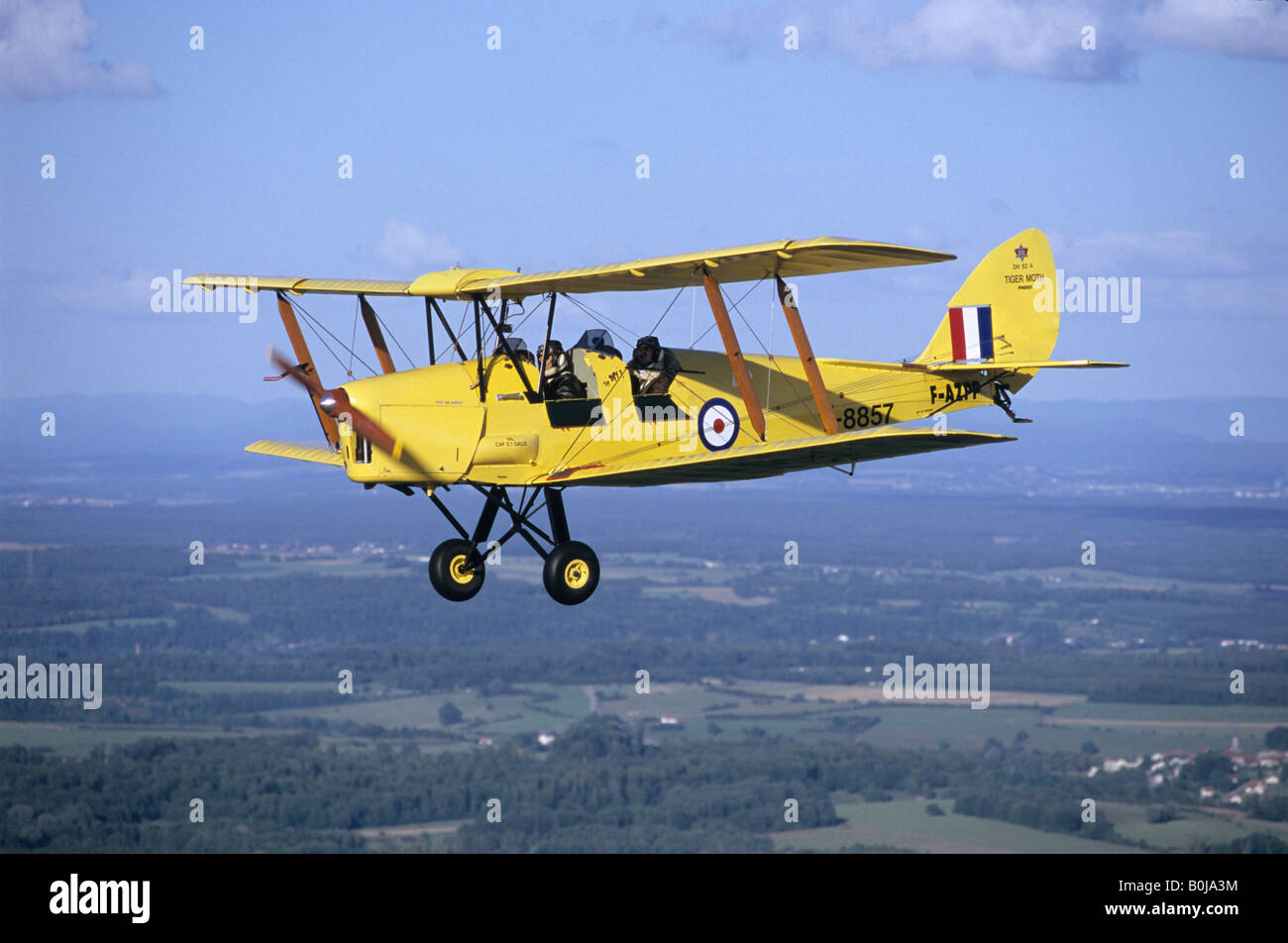 Old British trainer biplane De Havilland DH-82c Tiger Moth in flight ...