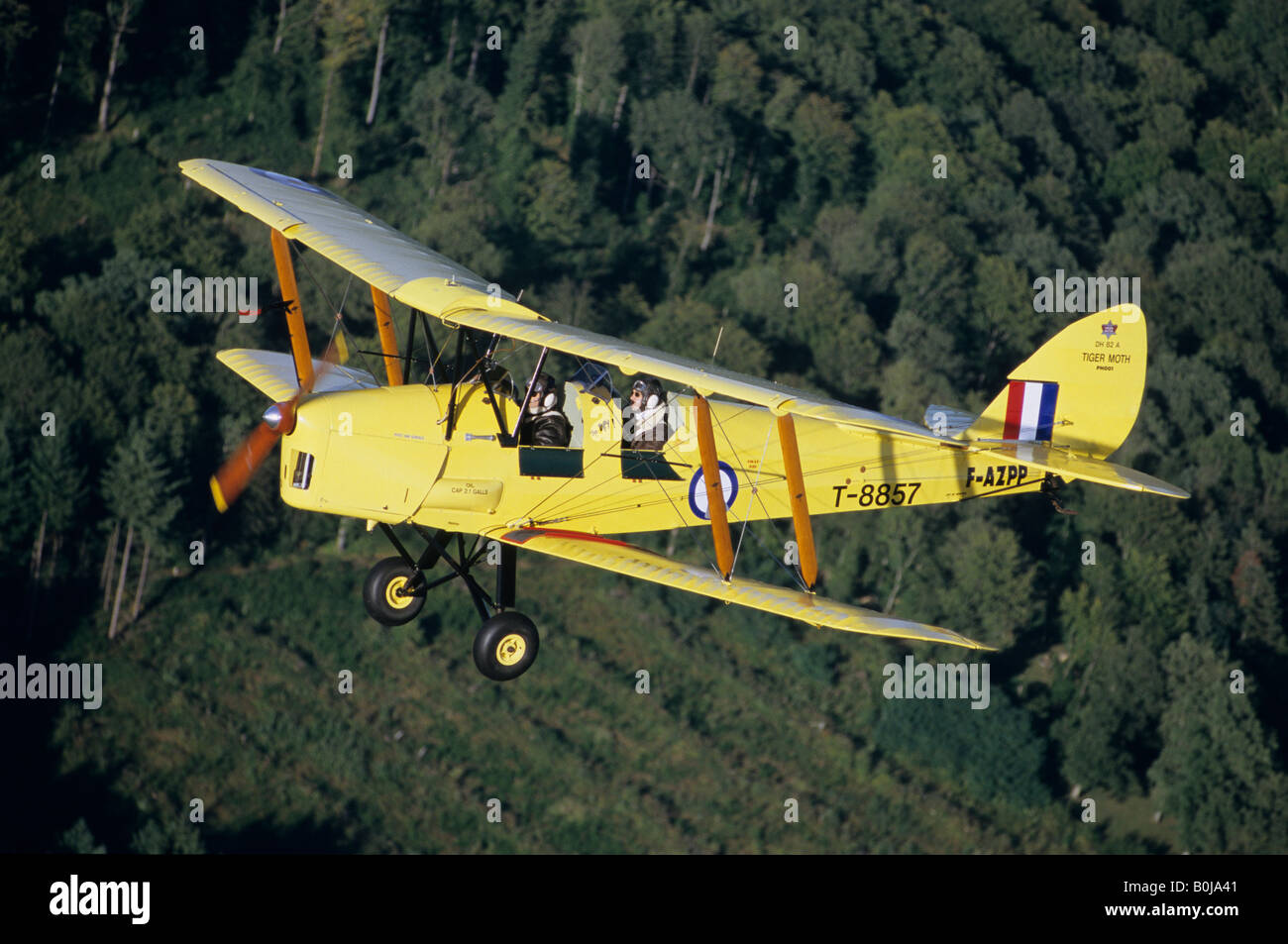 Old British trainer biplane De Havilland DH-82c Tiger Moth in flight ...