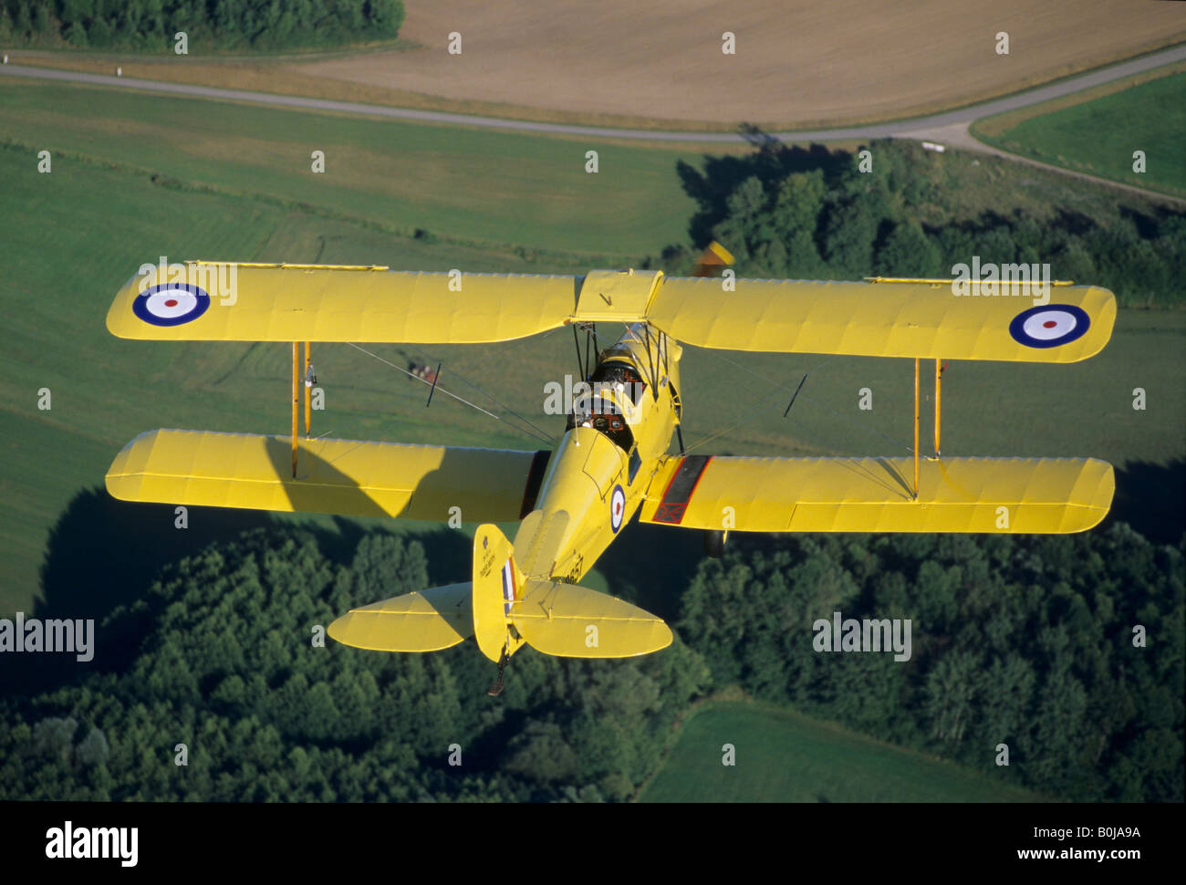 Old British trainer biplane De Havilland DH-82c Tiger Moth in flight ...