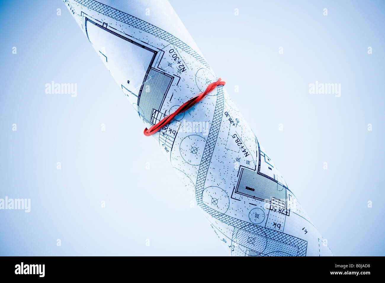 Construction blueprint rolled up with rubber band Stock Photo - Alamy