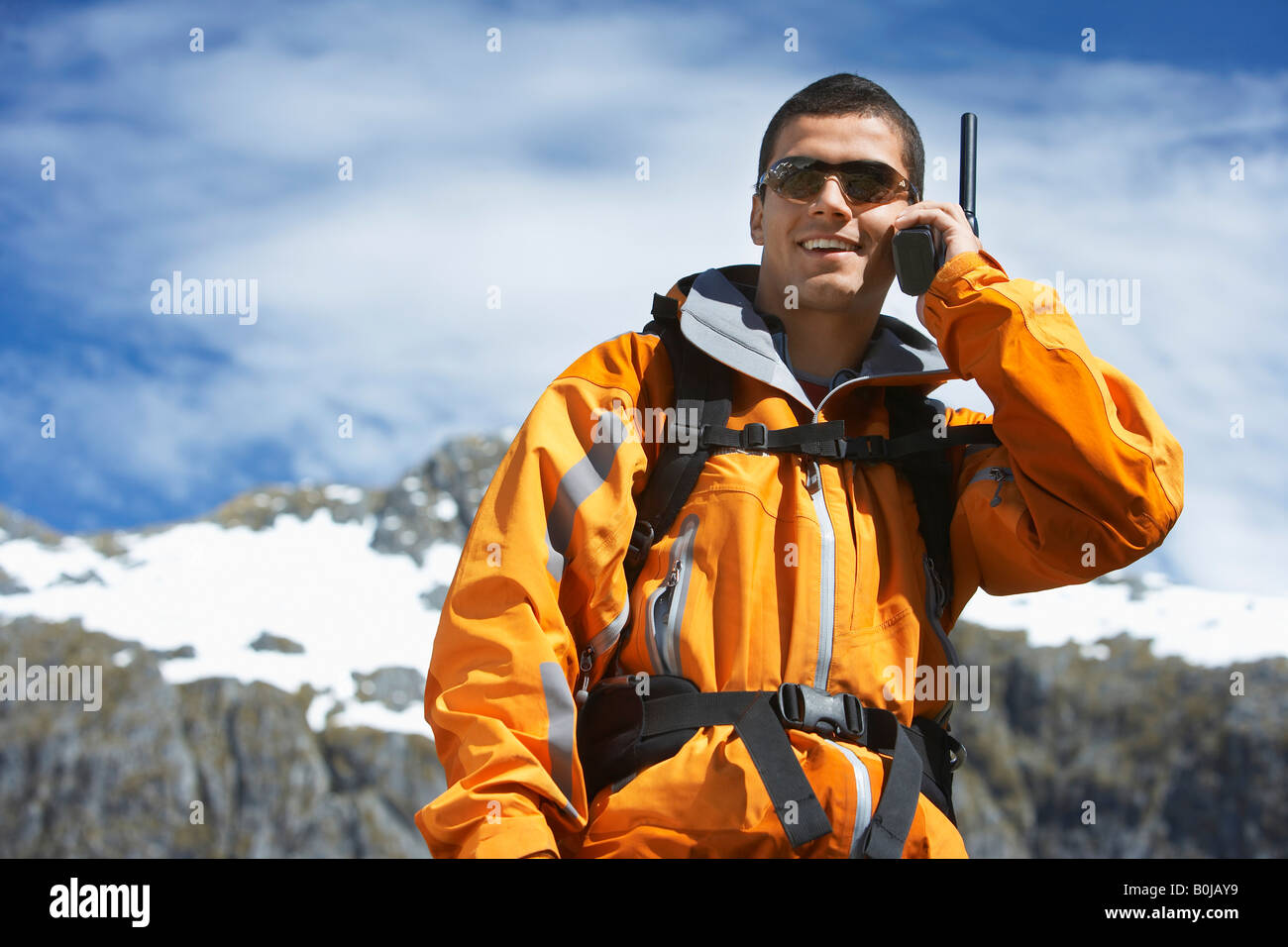 Man using walkie-talking on mountain peak Stock Photo - Alamy