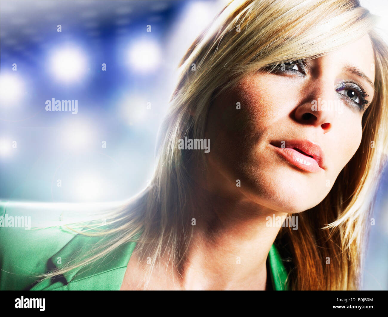 Woman with blonde hair in front of spot lights Stock Photo - Alamy