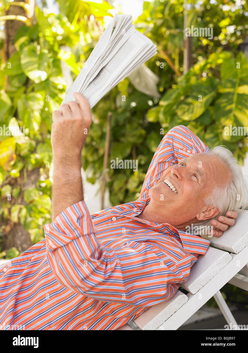 Man reclining on lounge chair hi-res stock photography and images - Alamy