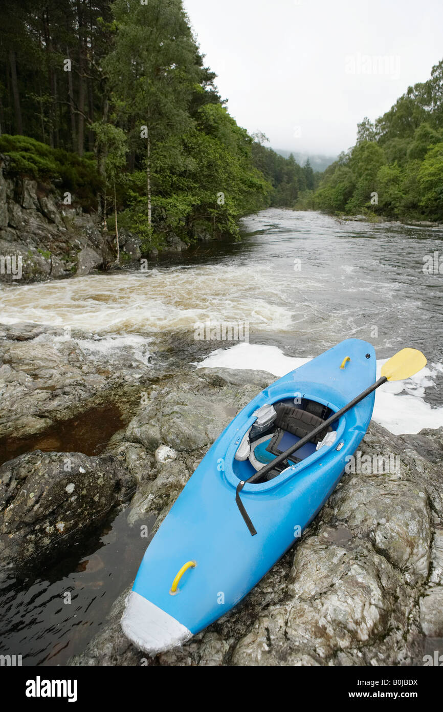 Blue kayak by river Stock Photo - Alamy