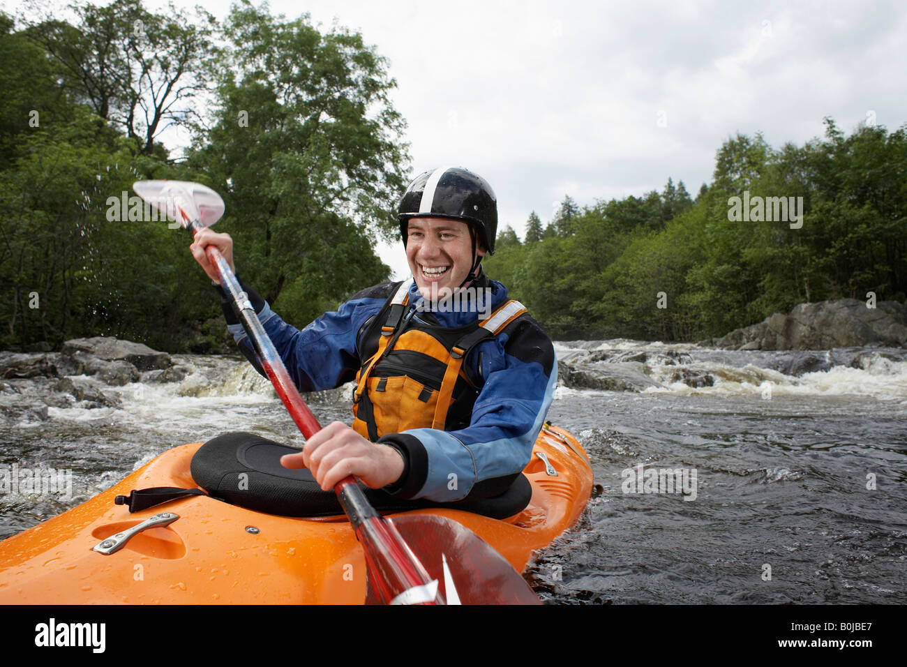 Man kayaking in river Stock Photo - Alamy