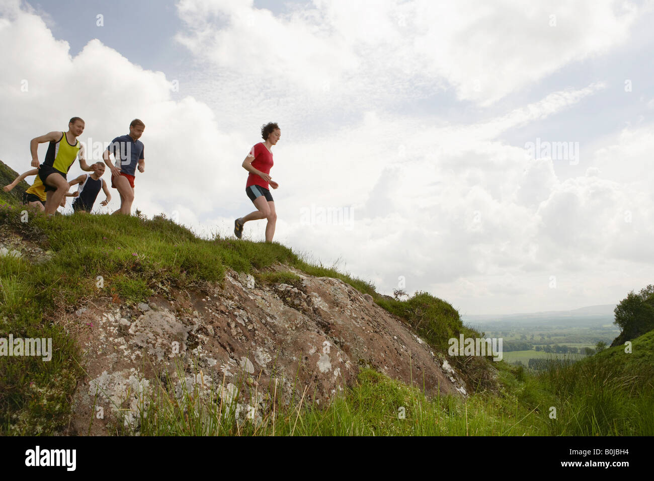 Group of people running in countryside Stock Photo - Alamy