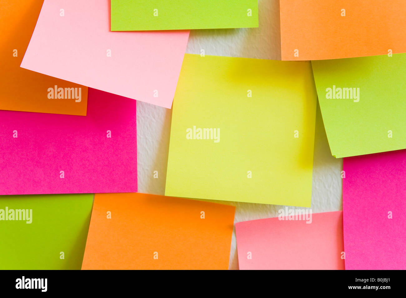 Blank sticky notes attached to a white wall Stock Photo - Alamy
