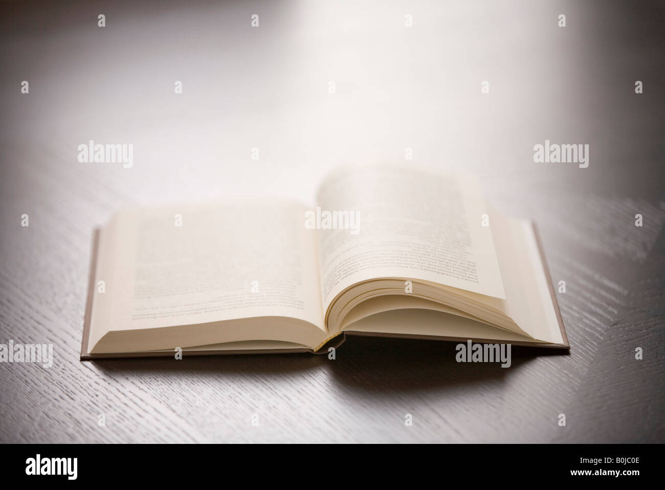 Open book on a table Stock Photo - Alamy