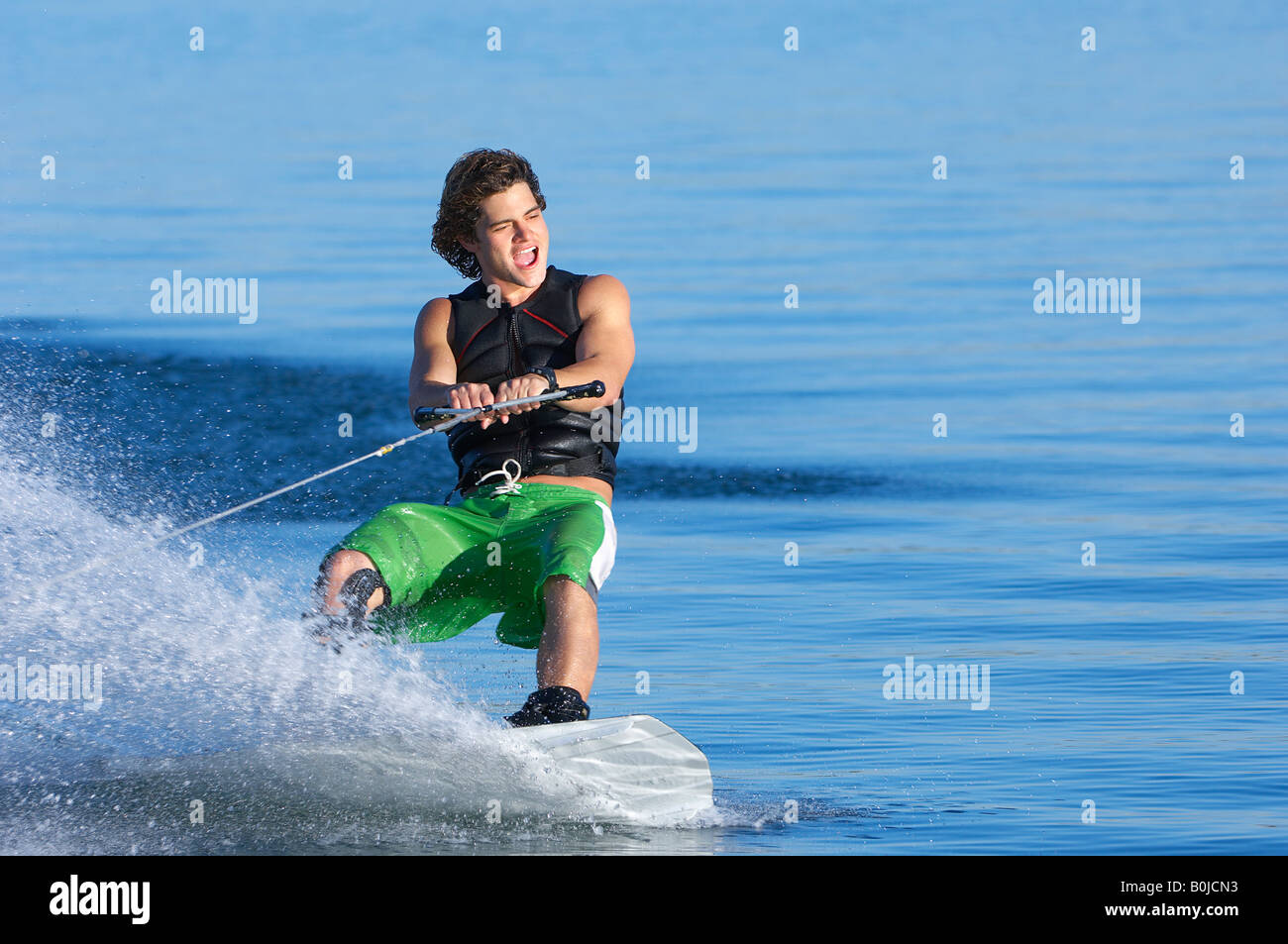 Young man wakeboarding on lake Stock Photo - Alamy