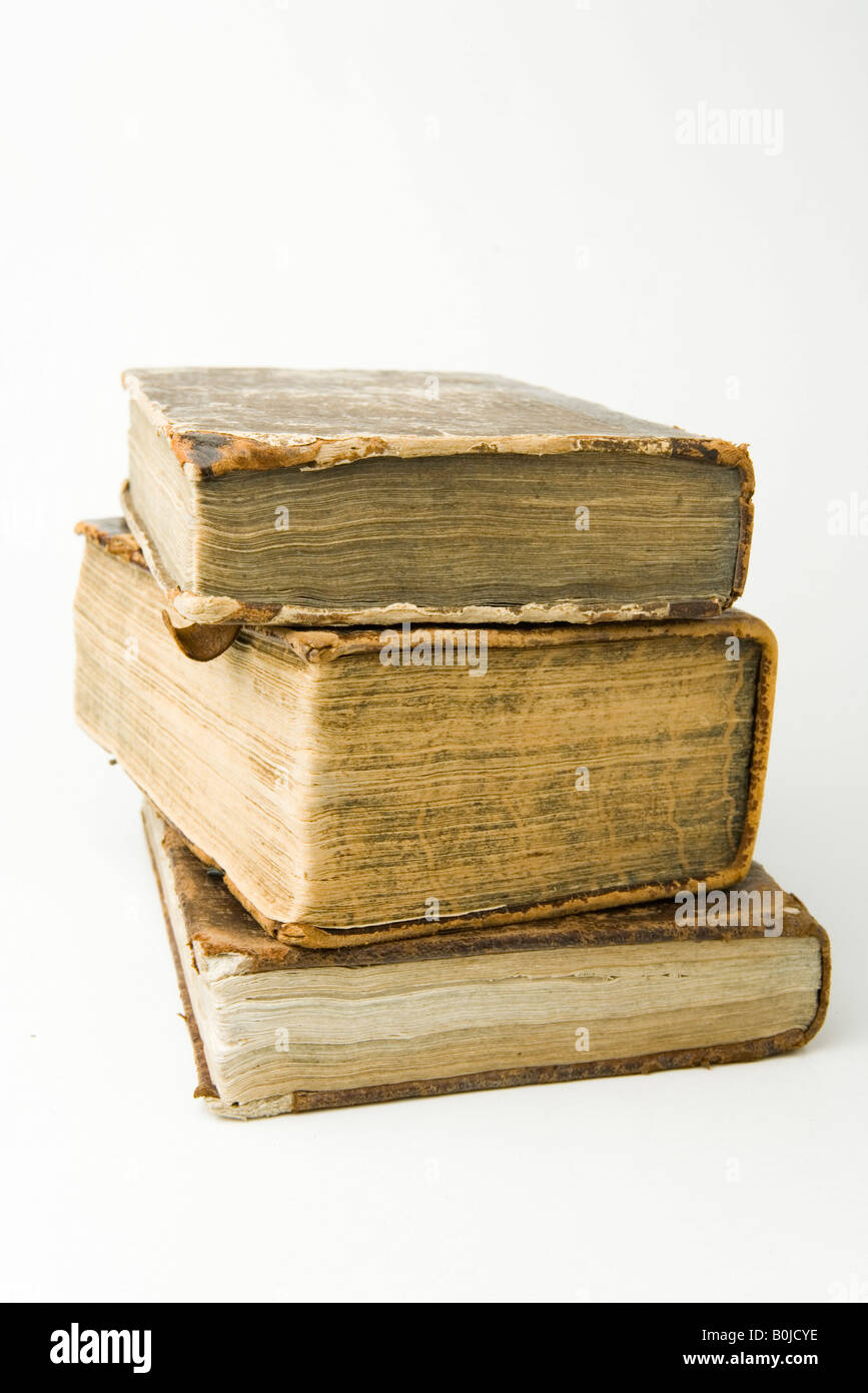 Antique books piled on a white background Stock Photo - Alamy