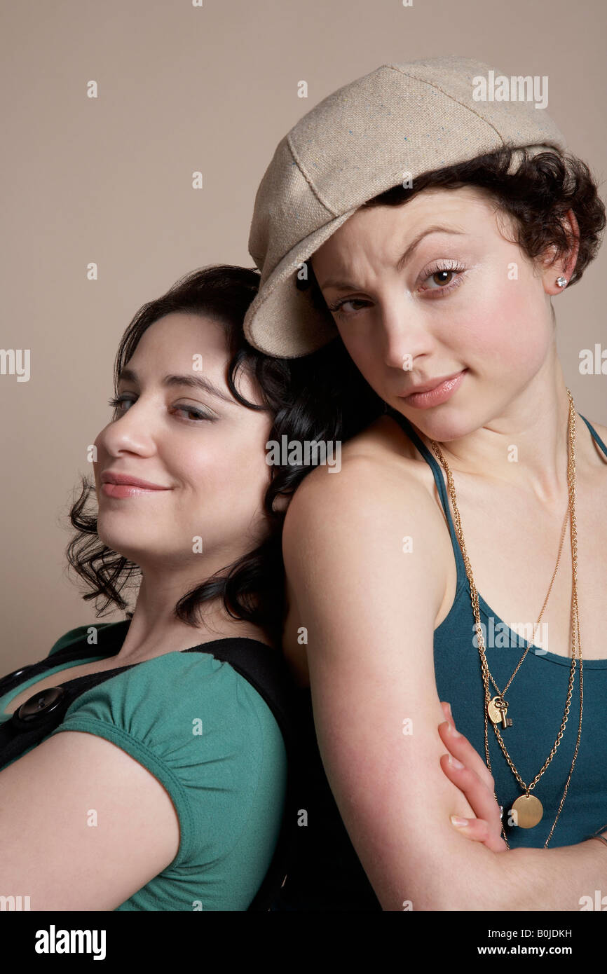 Two young women back to back, portrait Stock Photo - Alamy