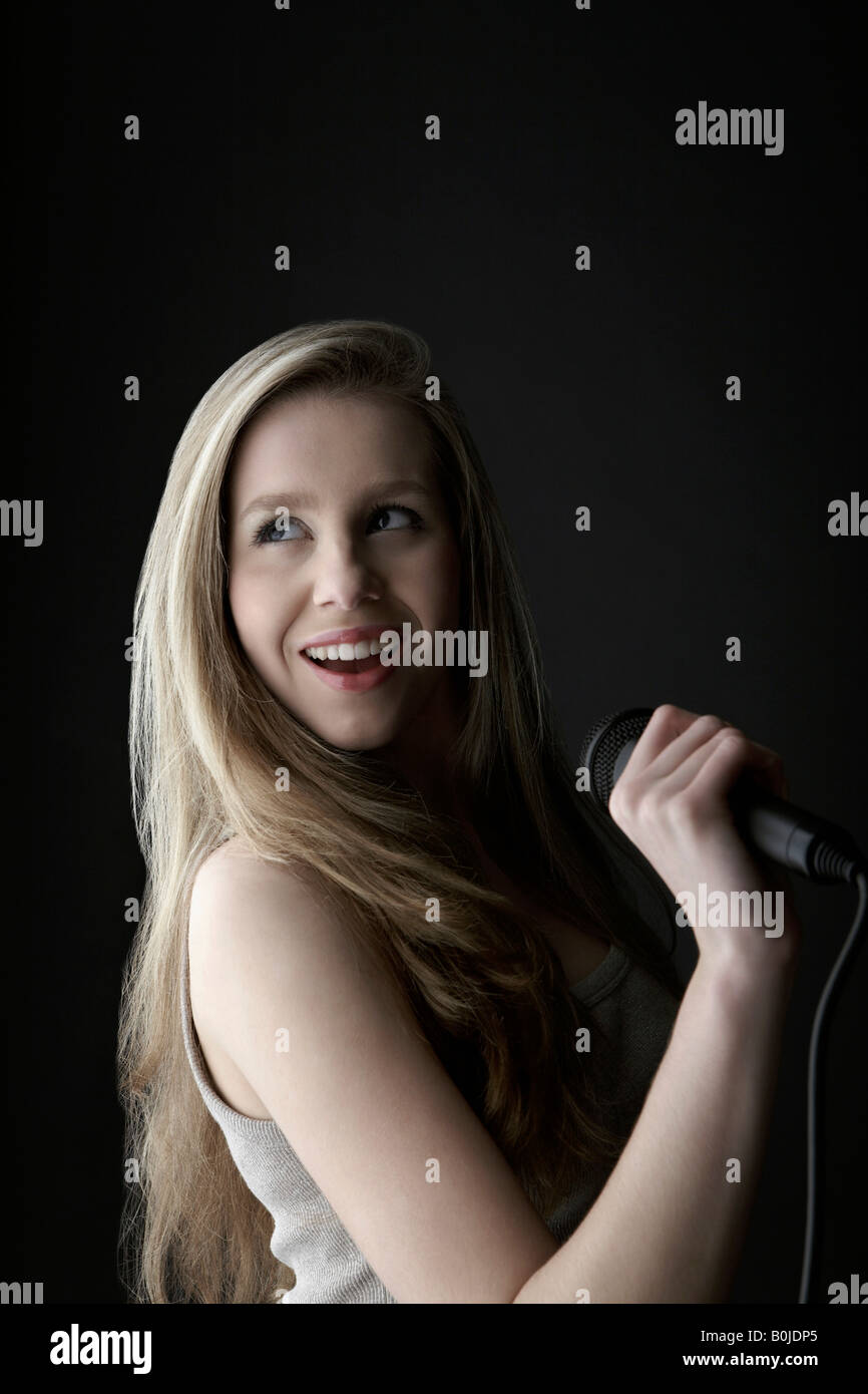 Standing looking away microphone singing performance hi-res stock ...