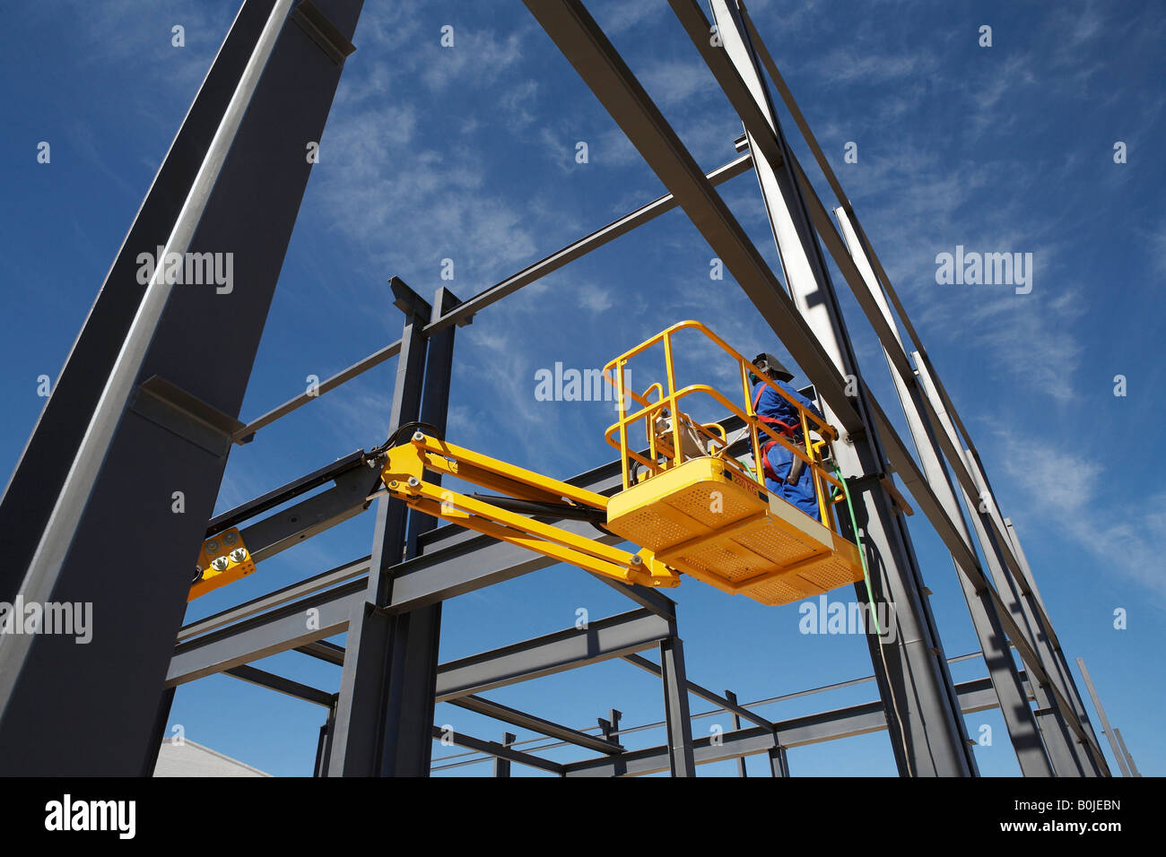 Welder working from cherry picker on warehouse construction Stock Photo ...