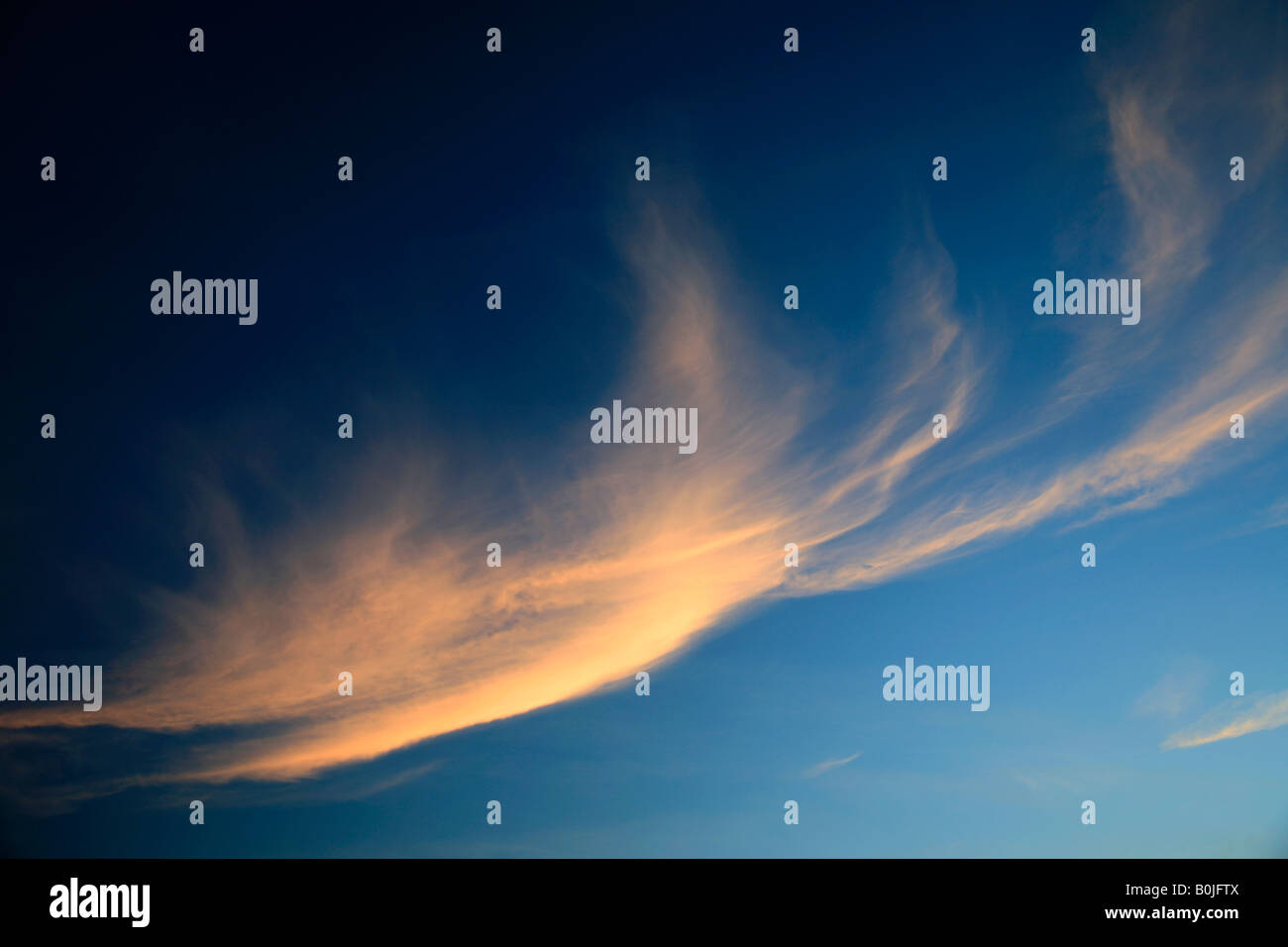 Generic Cirrus Uncinus sunset clouds in a deep blue polarised sky Stock ...