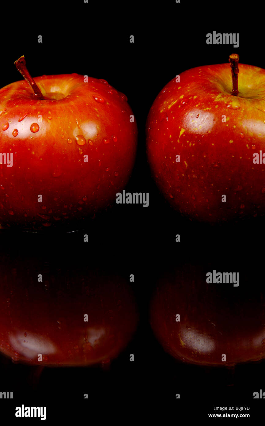 Red Apples isolated against a black background Stock Photo - Alamy