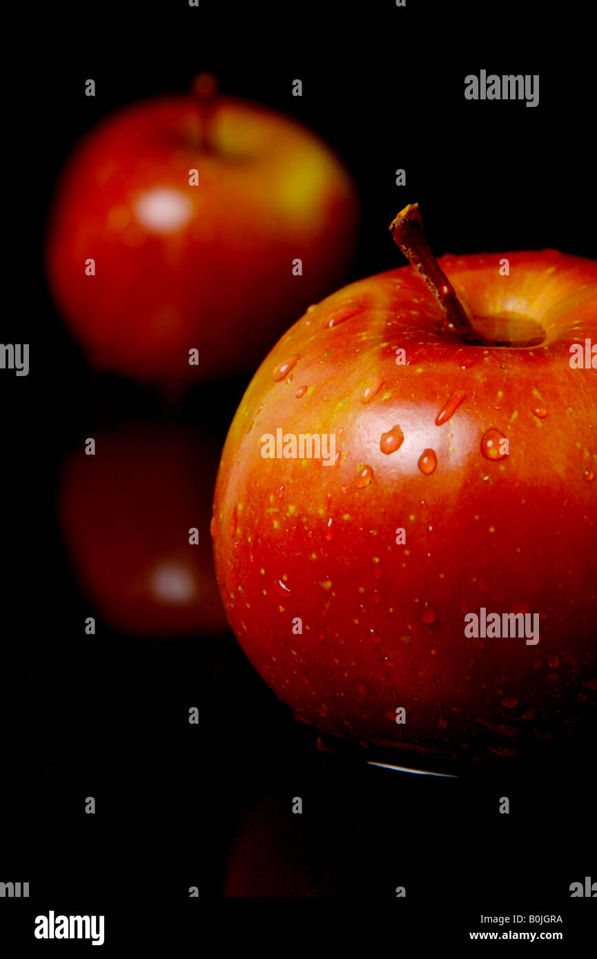 Red Apples isolated against a black background Stock Photo - Alamy