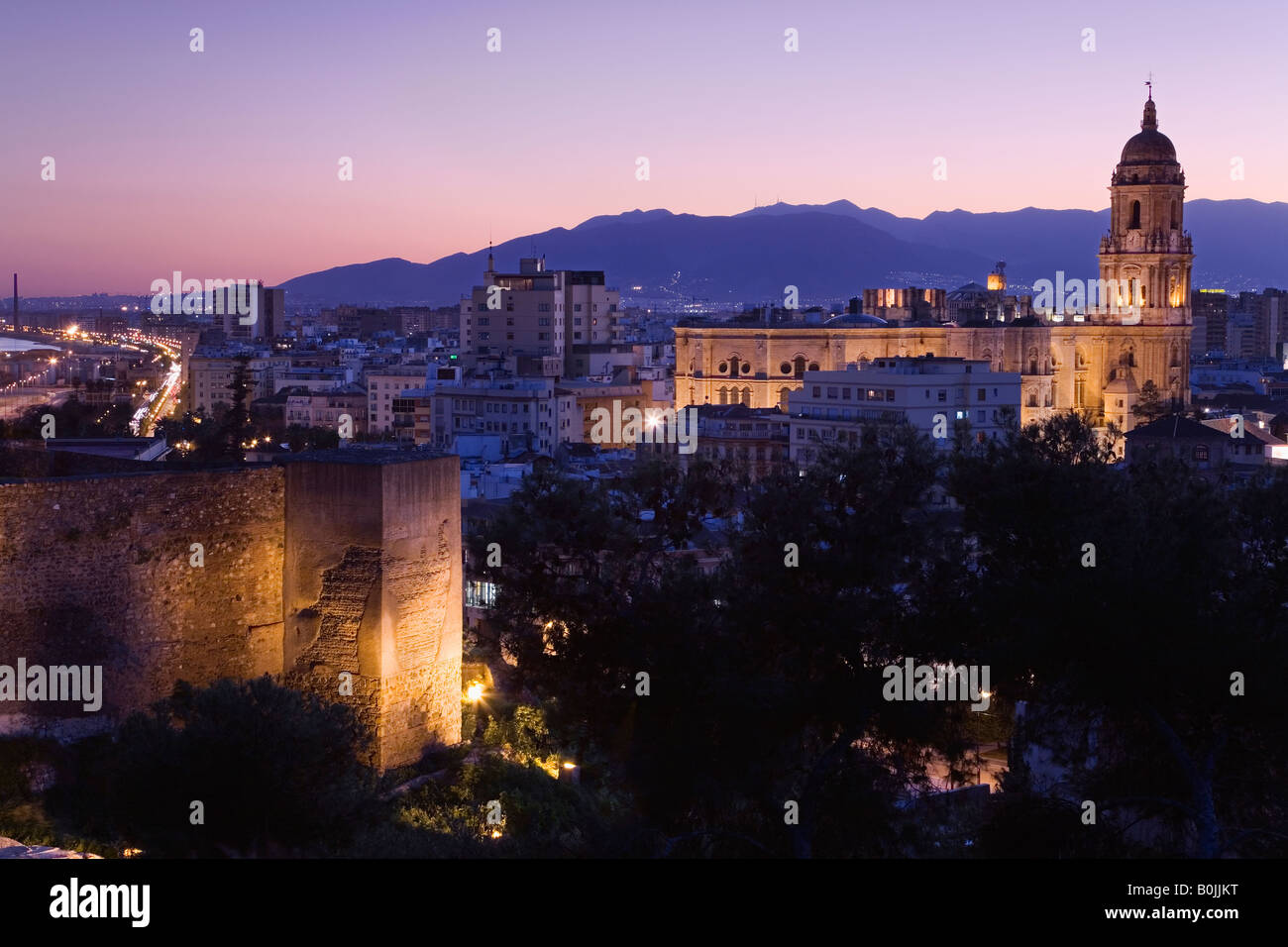 Malaga City, Spain. Cathedral and walls of Alcazaba, sunset Stock Photo ...