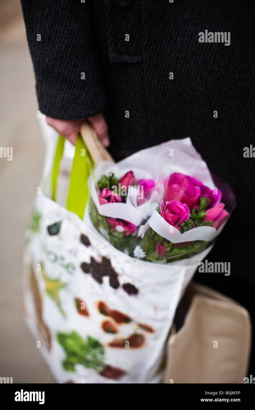 Womans hand holding a Waitrose reusable shopping bag Stock Photo - Alamy