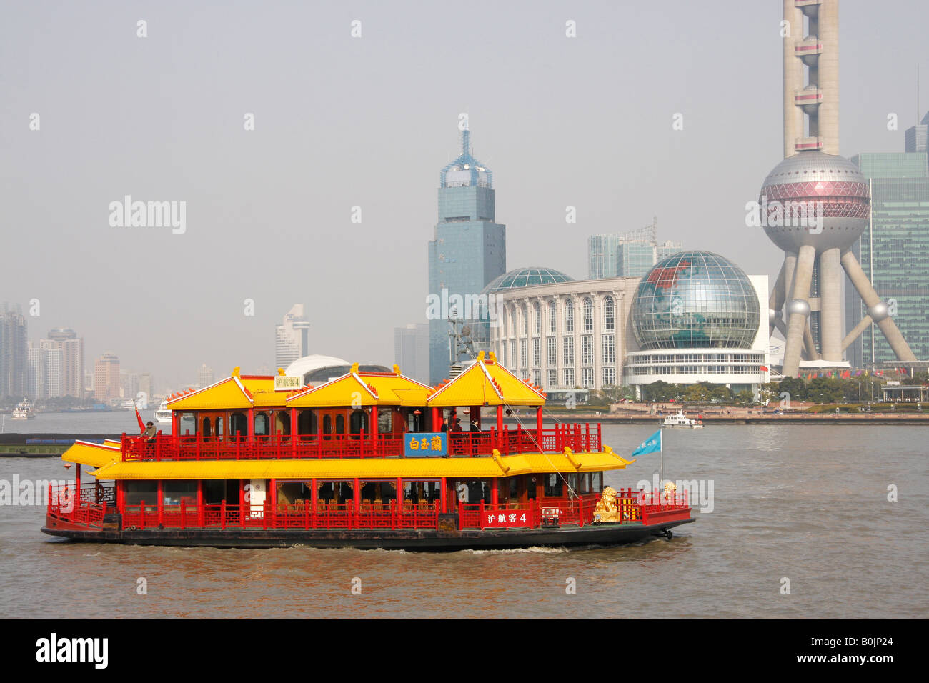 A sightseeing boat sailing along the Huanpu river in front of the ...
