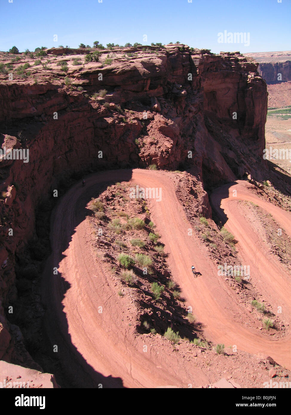 Mountain bikers wind their way down a switchback road, Green River ...