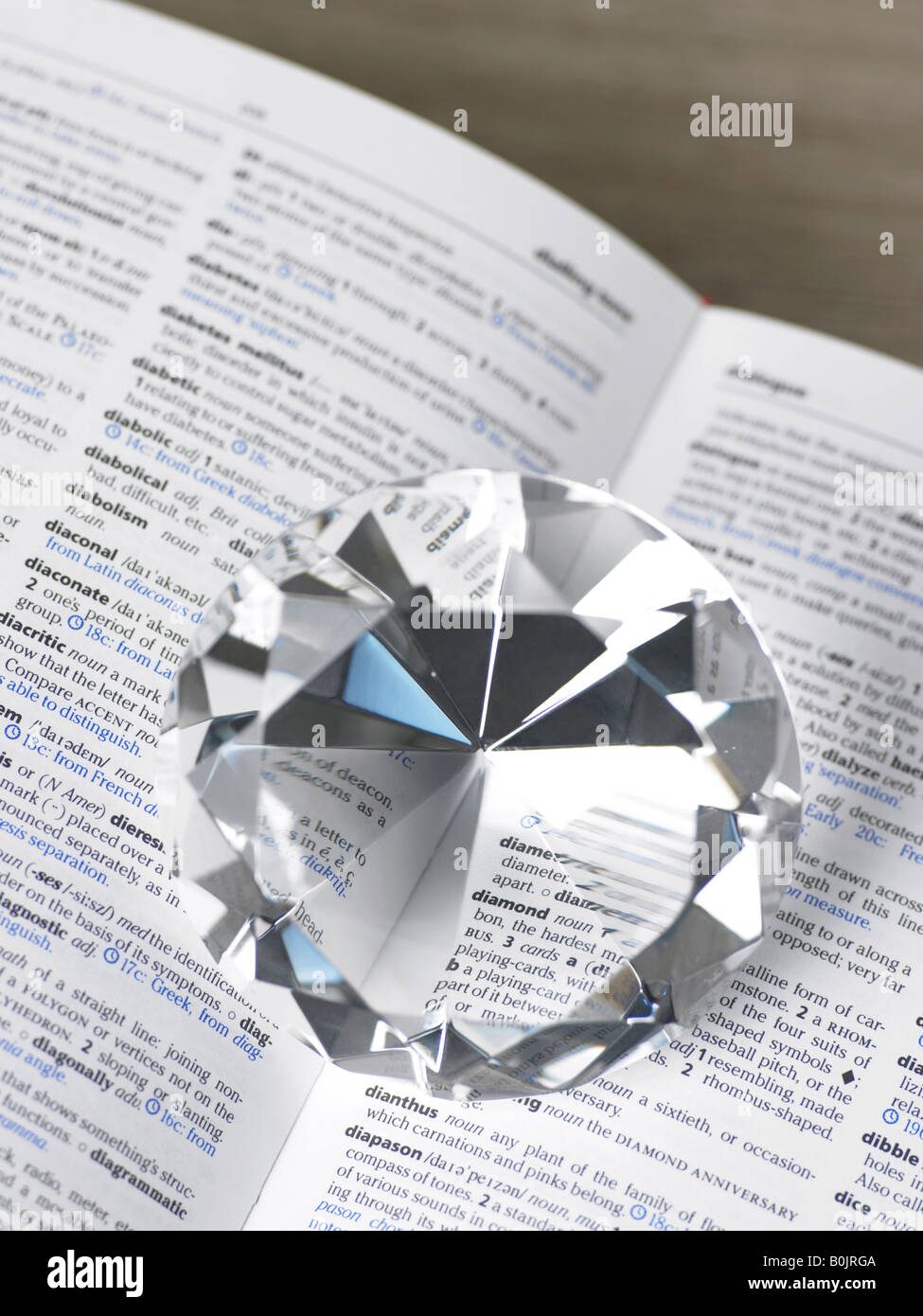 diamond paperweight on open book Stock Photo - Alamy