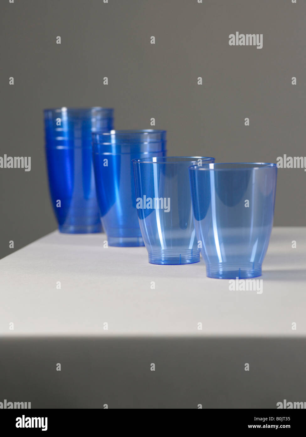 blue plastic cups on grey background Stock Photo - Alamy
