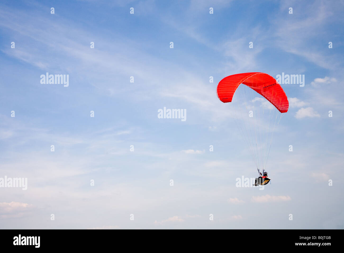 Red Paraglider and blue sky Stock Photo - Alamy
