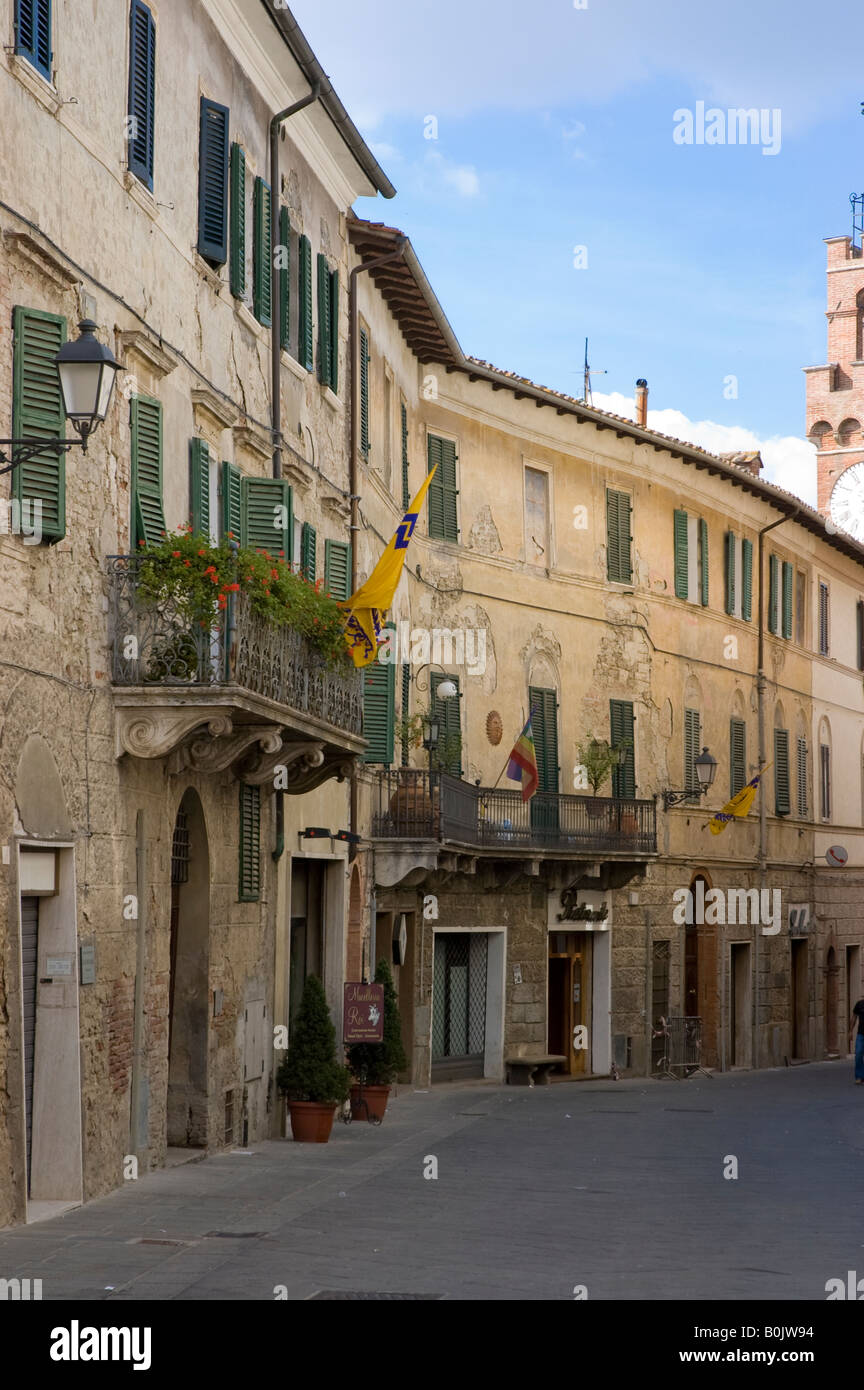 Typical shuttered buildings on the street of Asciano in Tuscany Italy ...