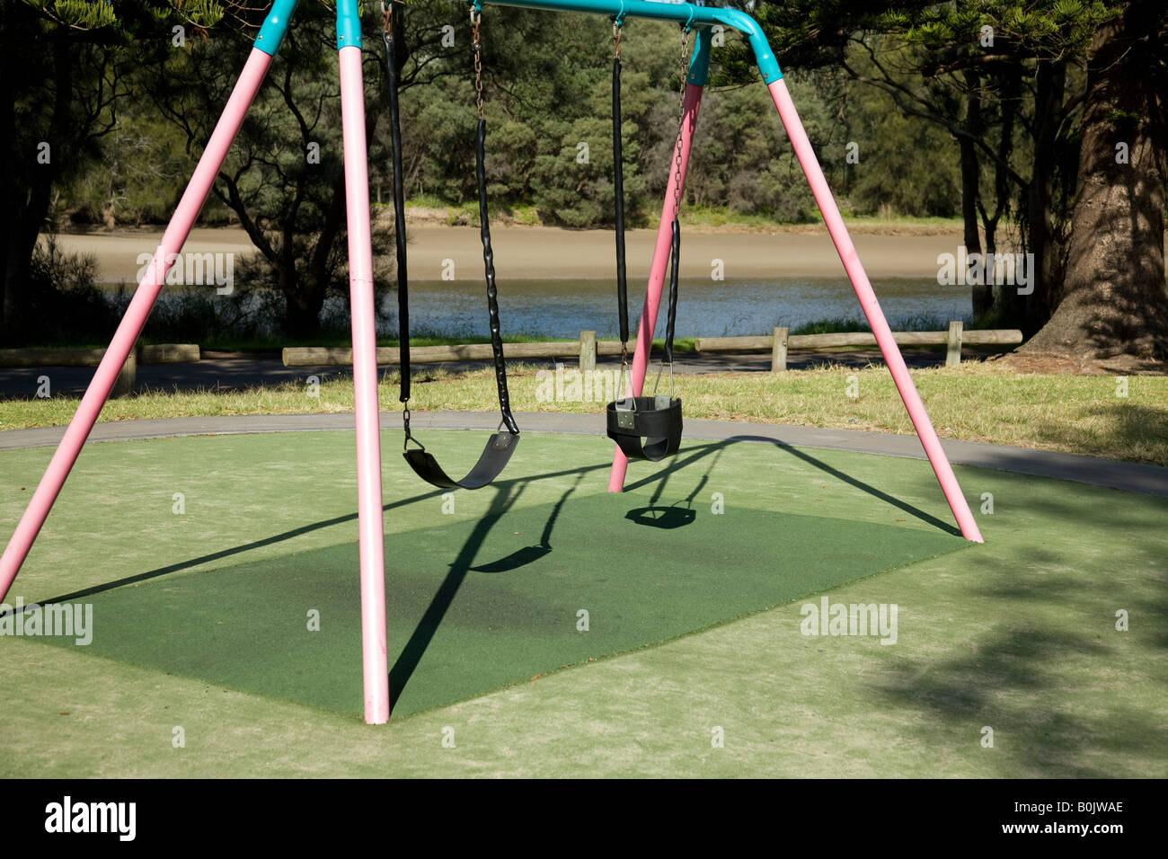 swings at a childrens playground Stock Photo - Alamy