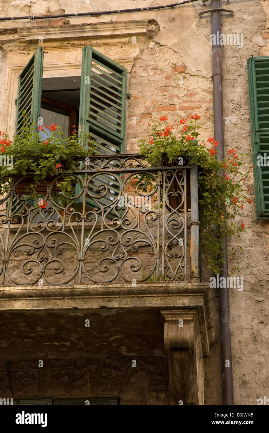 run down Italian balcony with shutters and flowers Stock Photo - Alamy