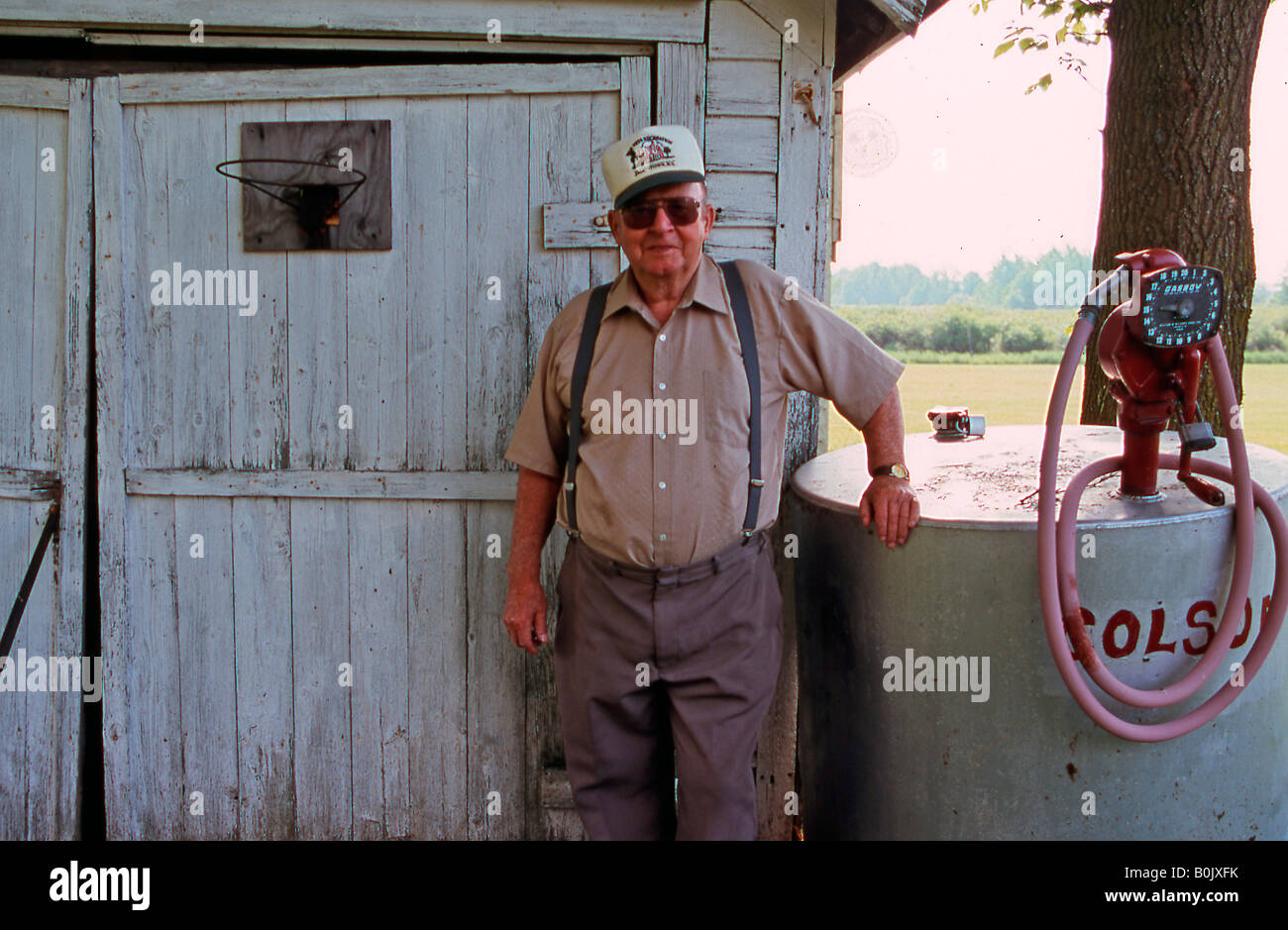 Older man outside a barn Stock Photo - Alamy