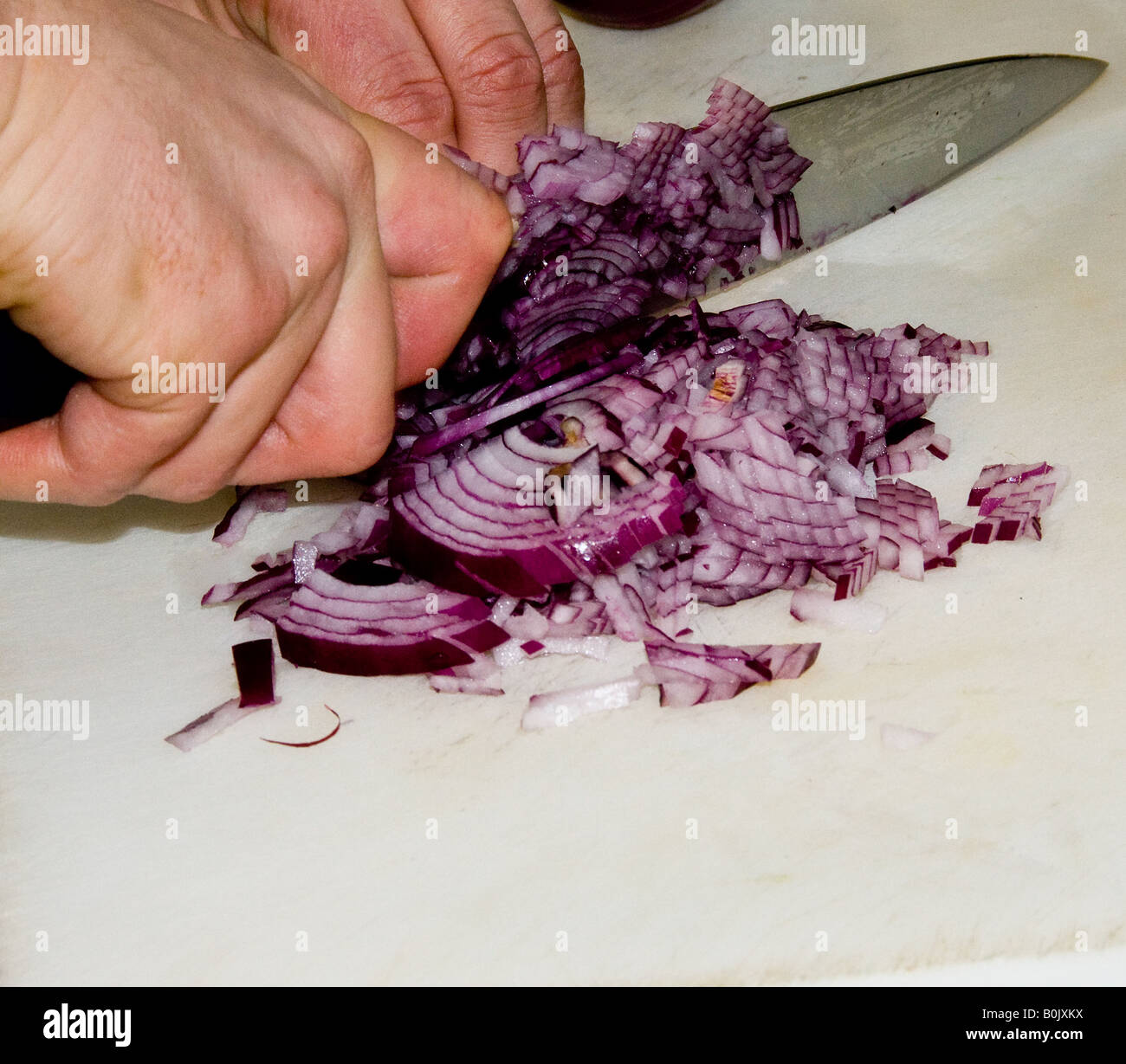 Food preparation - A red onion being sliced and diced Stock Photo - Alamy