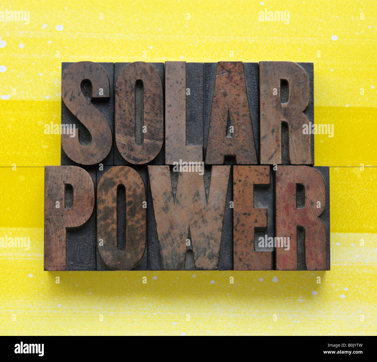 the phrase 'solar power' in letterpress wood type on a yellow ...