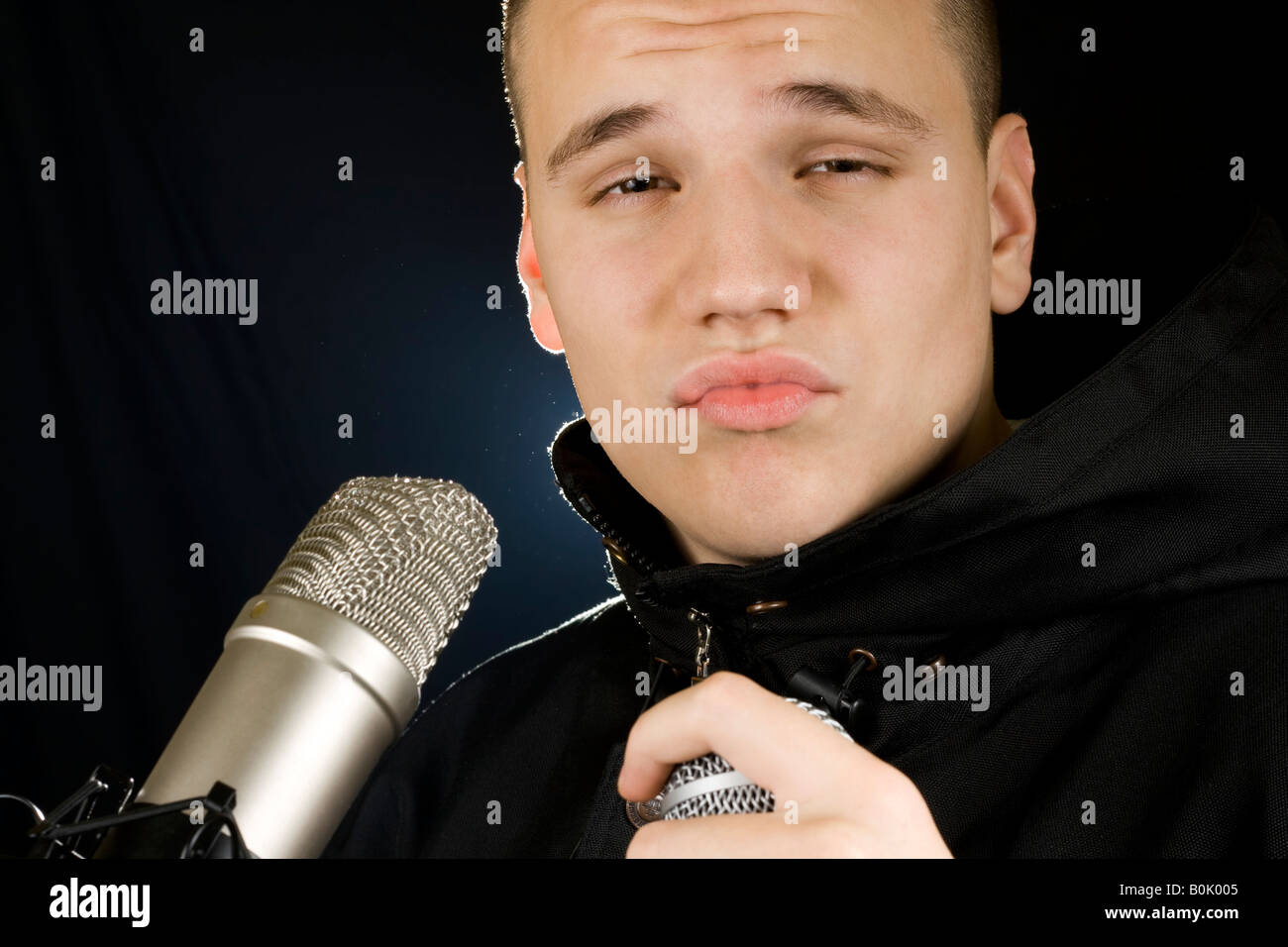Teenager boy acting like singing and making a face Studio shot Stock ...