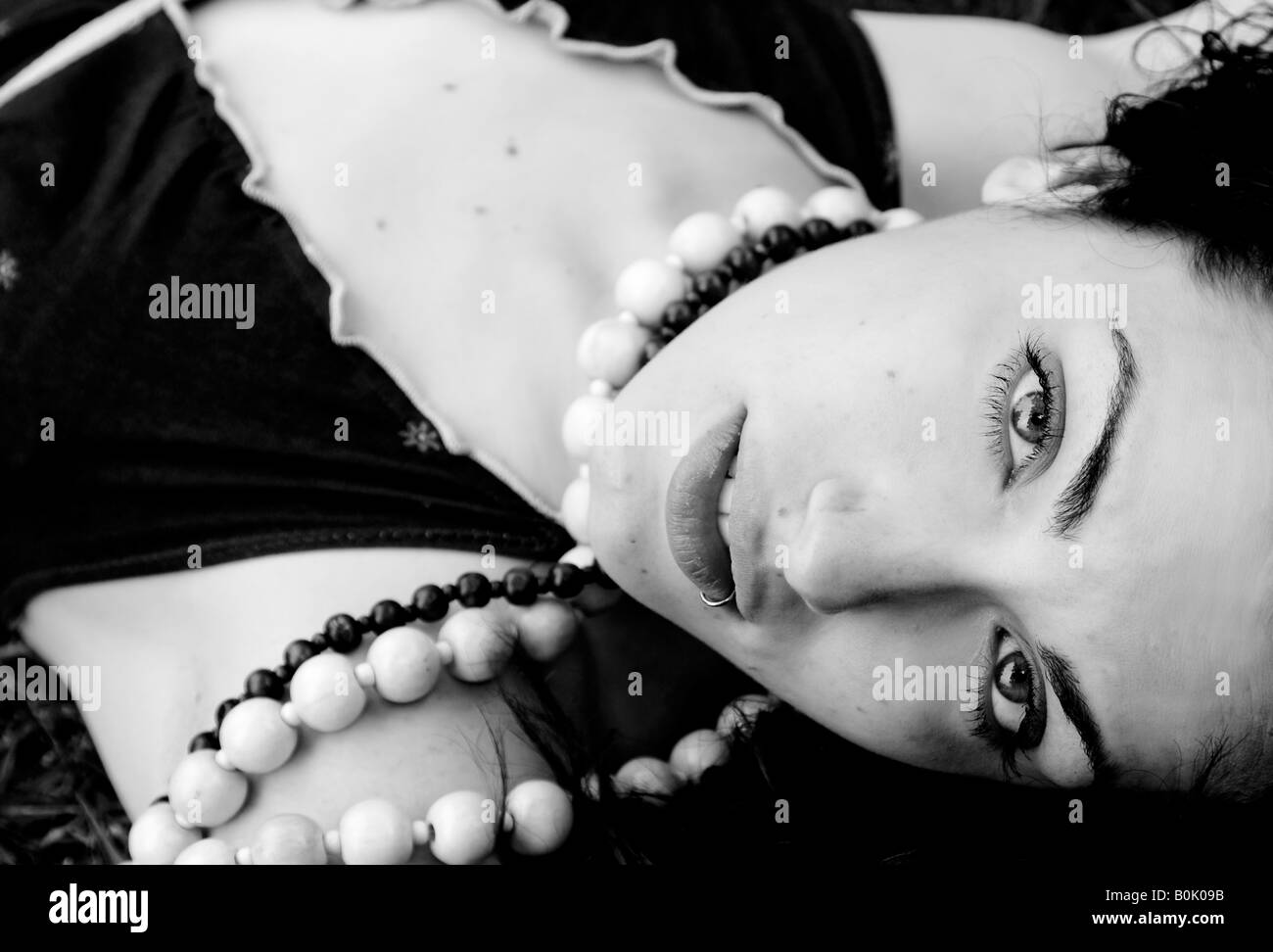 Laying woman staring at camera in black and white Stock Photo - Alamy