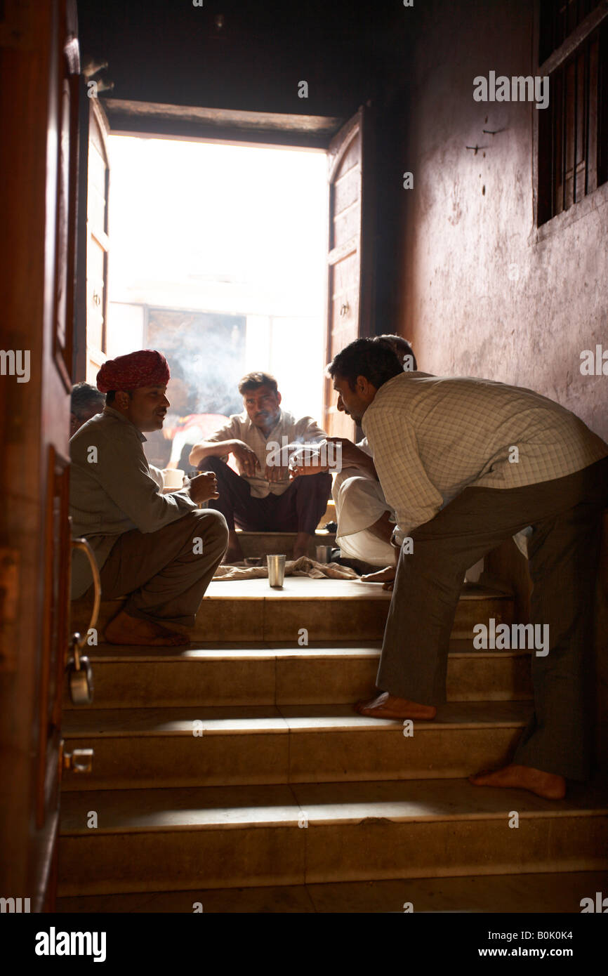 Tea break Chai on steps at the edge of a temple Rajasthan Thar Desert ...
